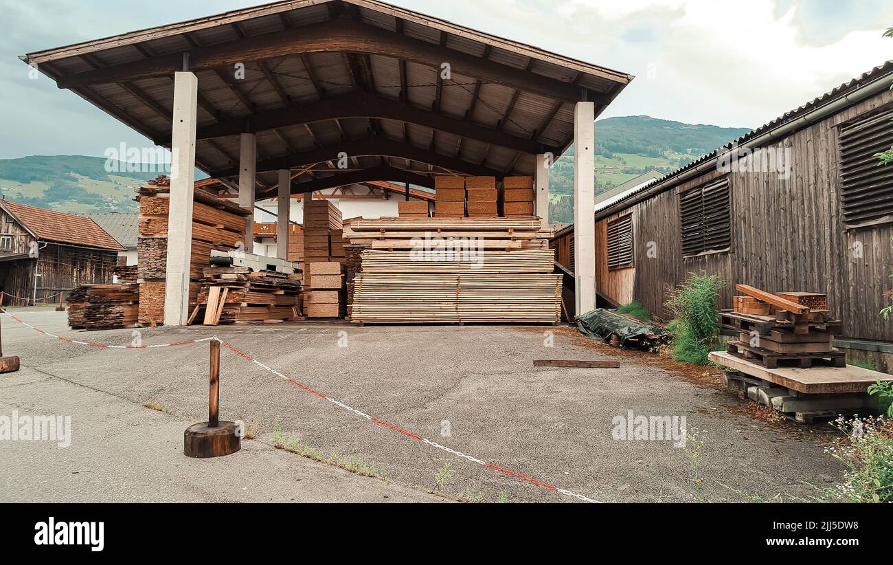 Big storage of wooden bricks in the village in mountains. High quality ...