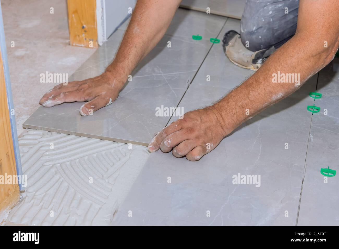Construction workers installing leveling system hi-res stock ...