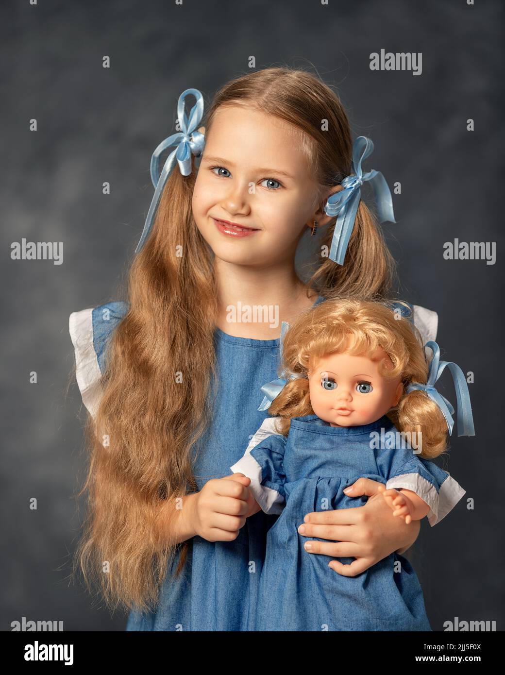 Child holding doll hi-res stock photography and images - Alamy