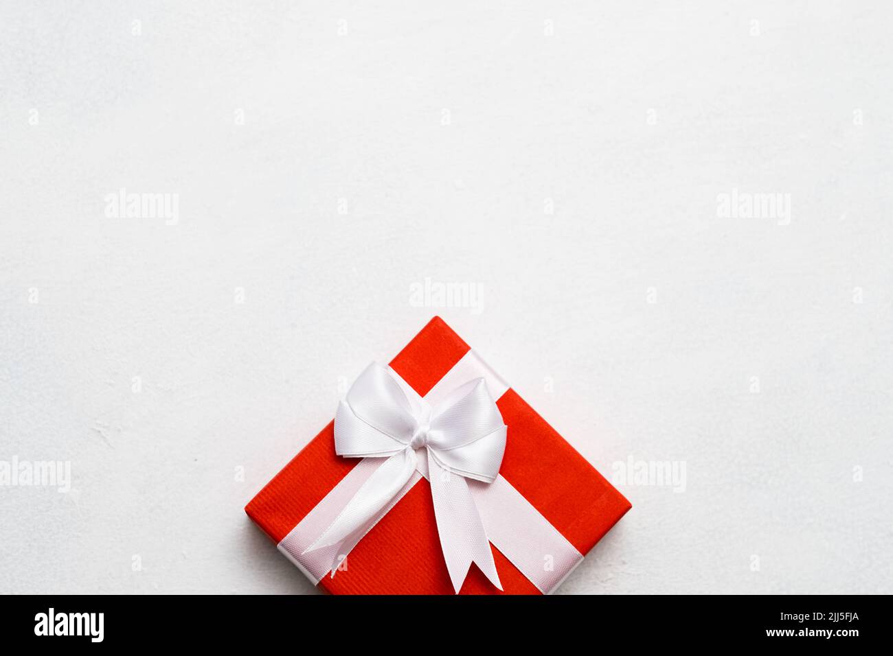 Red closed gift box on white background Stock Photo - Alamy