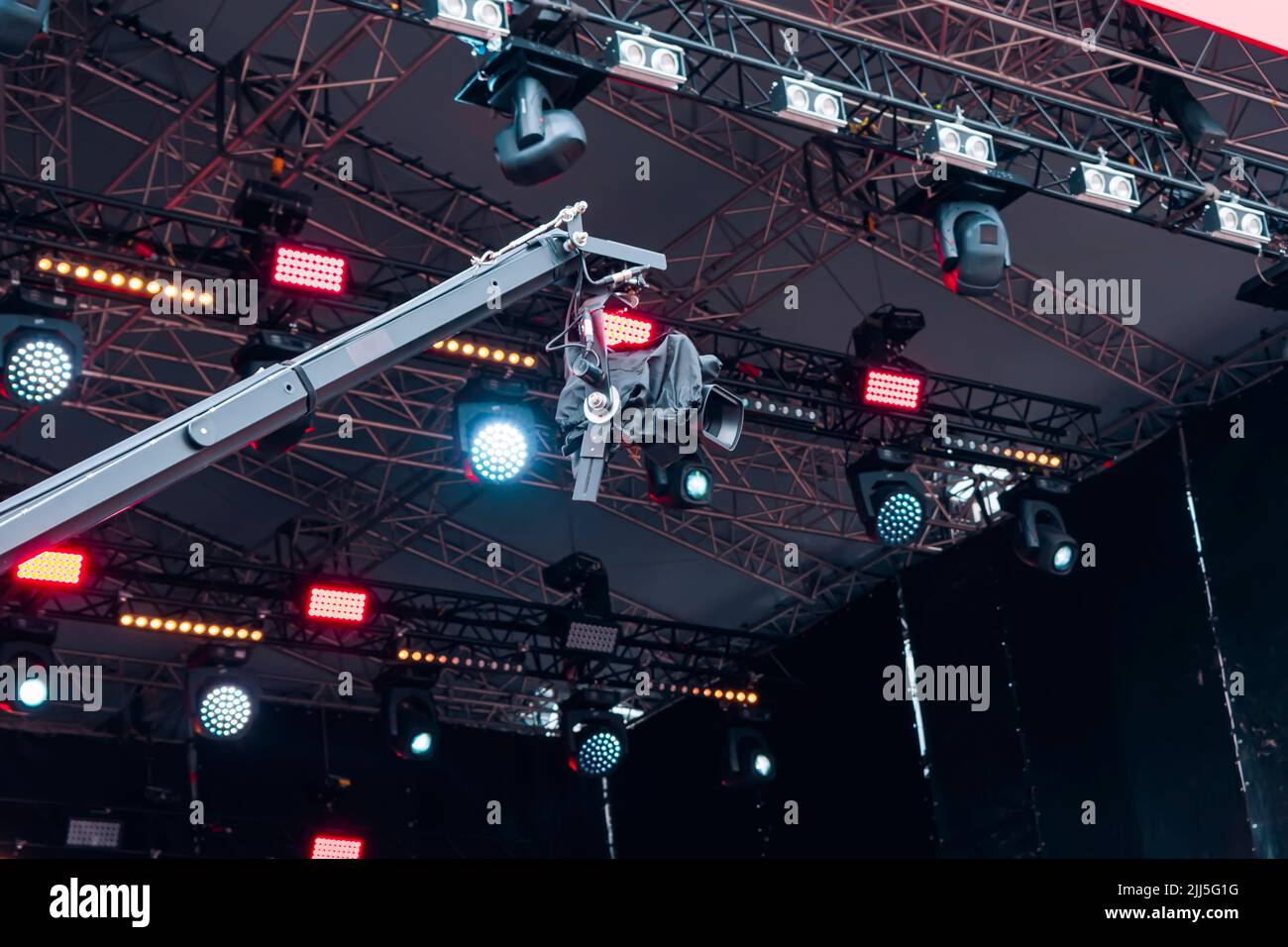 Movie camera filming a musical concert on the background of stage ...