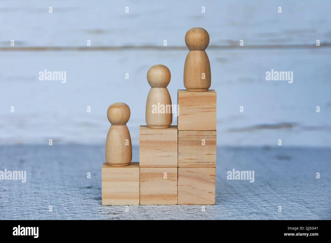 Wooden people figures on top of wooden blocks. Career growth and ...