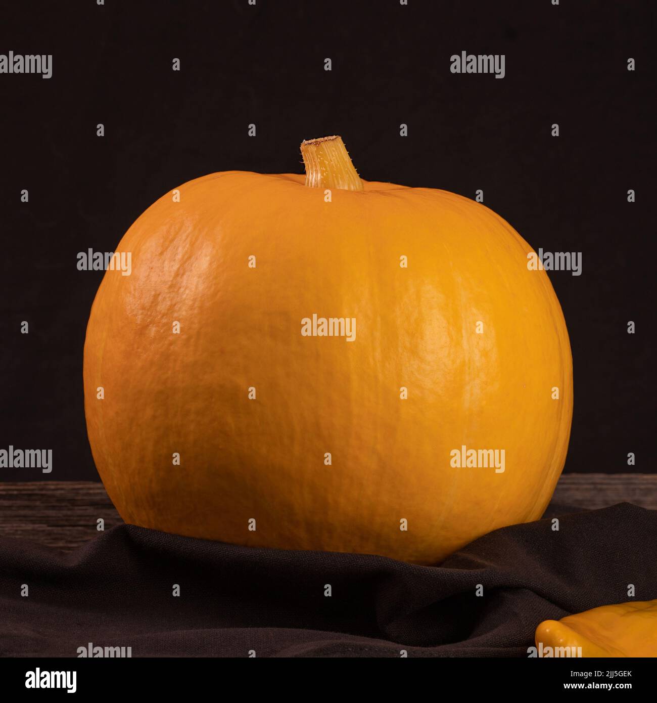 Yellow pumpkin and long pepper on a wooden old table, space for text ...