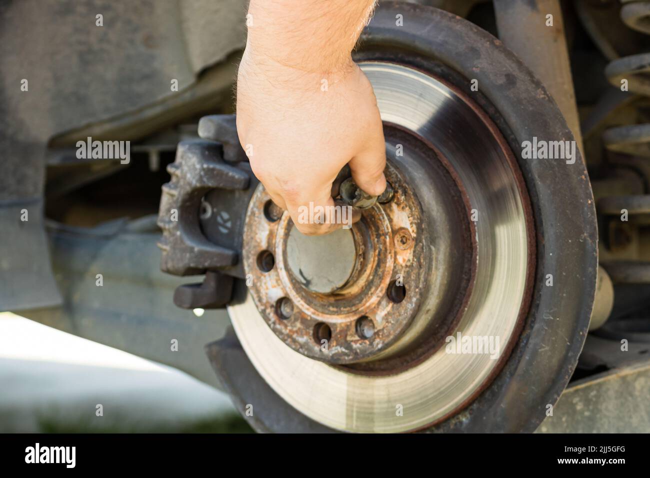 Mechanic cleaning and fixing the brake system of a car in Romania ...
