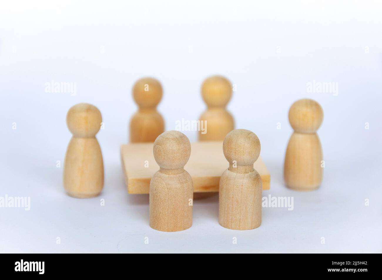Wooden people figures having business meeting with customizable spare ...