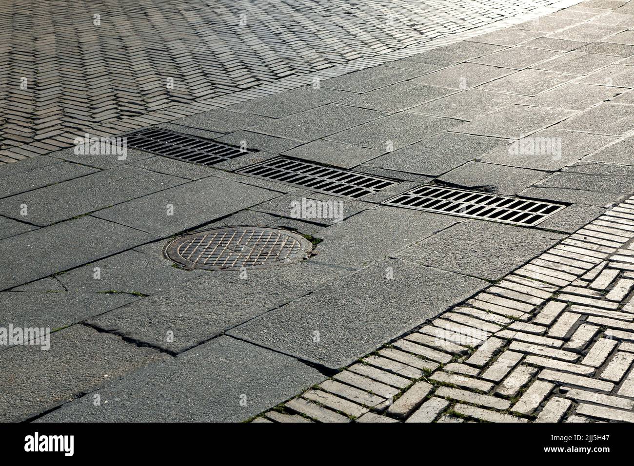 round iron manhole with hatches rectangular gratings of the drainage ...