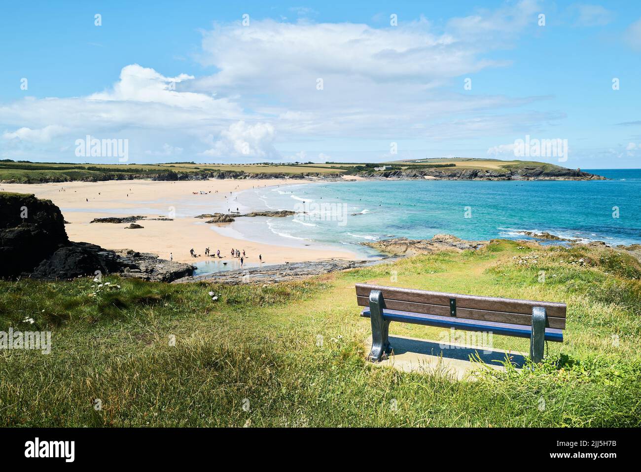 Bench on a cliff top overlooking the sandy beach at Harlyn Bay ...