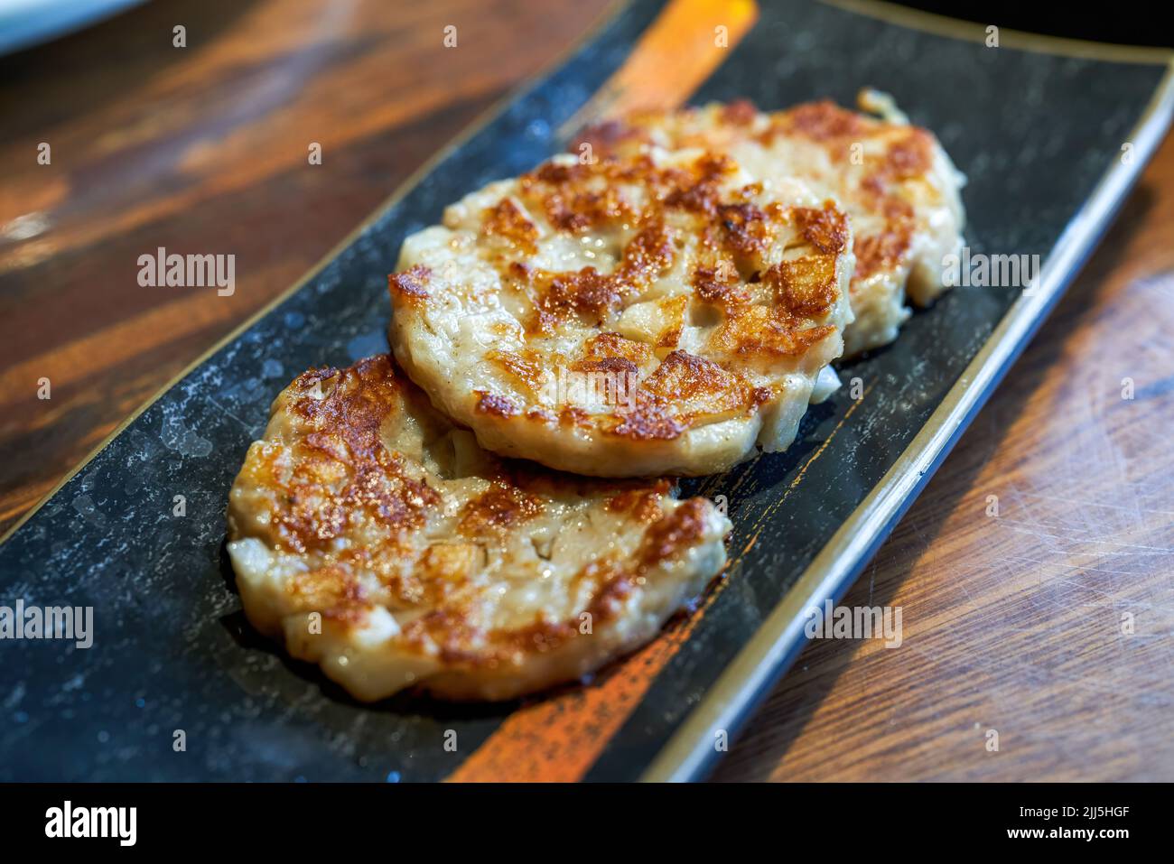 A delicious pan-fried lotus root cake Stock Photo - Alamy