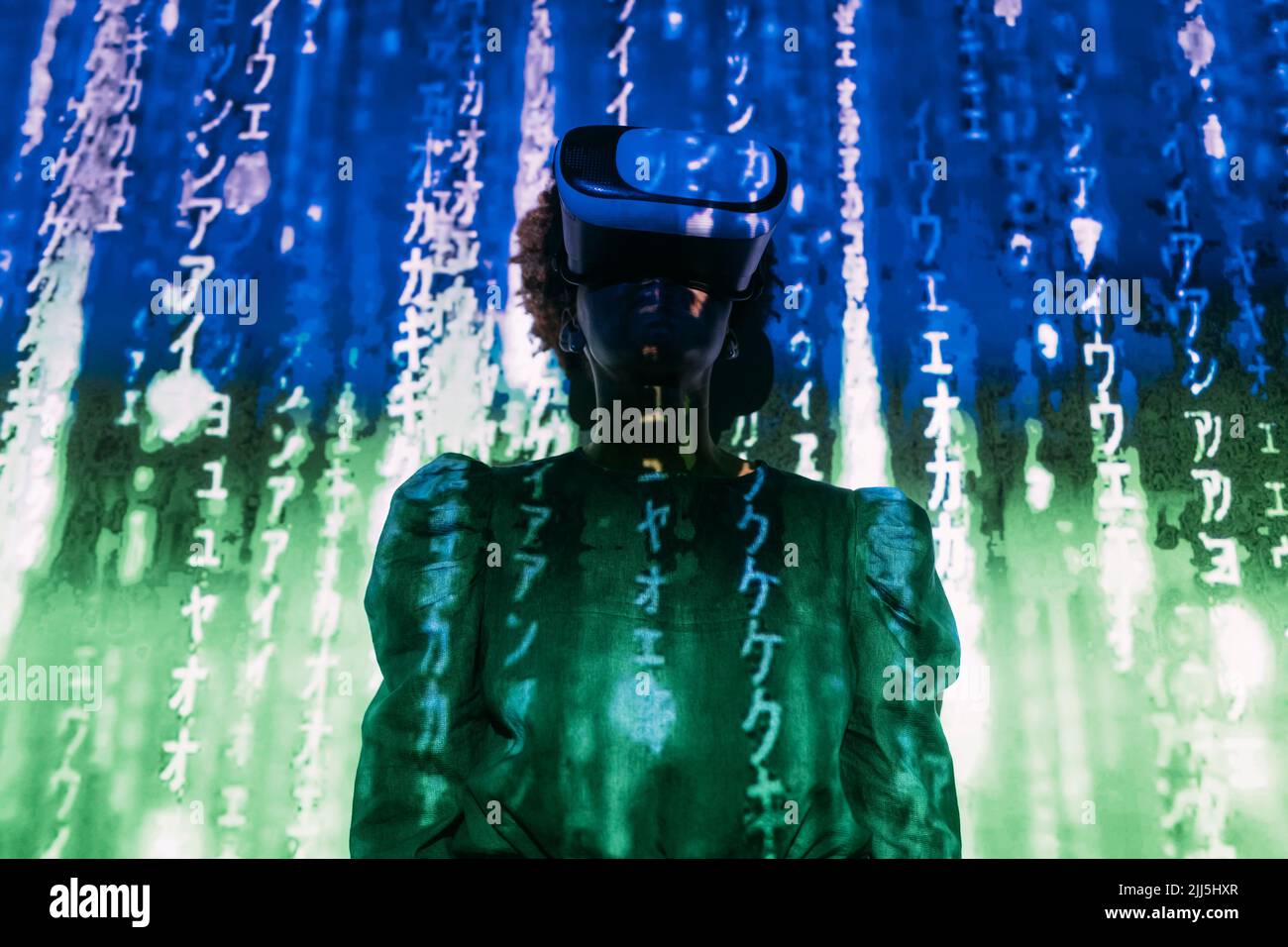 Digital code falling on woman wearing virtual reality simulator in ...