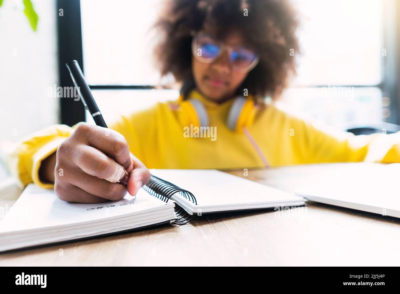 Girl writing in diary sitting in cafe Stock Photo - Alamy