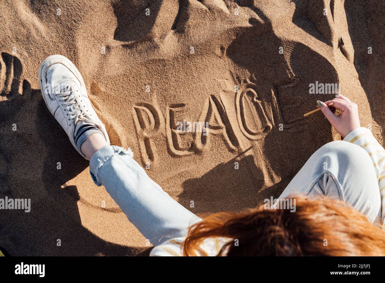 One woman writing word sand hi-res stock photography and images - Alamy