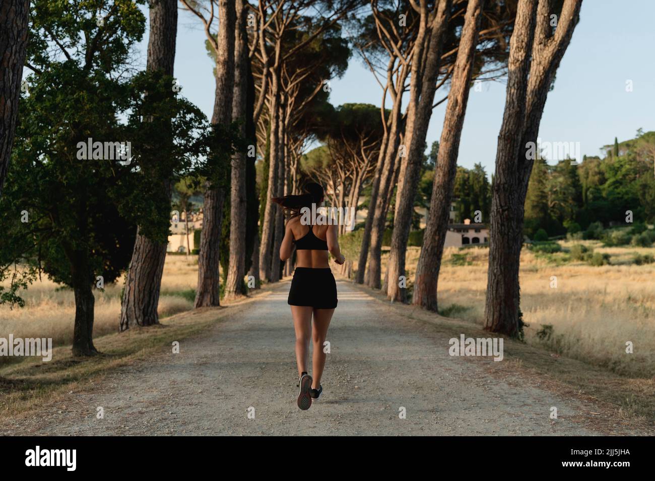 Back view woman jogging on hi-res stock photography and images - Alamy