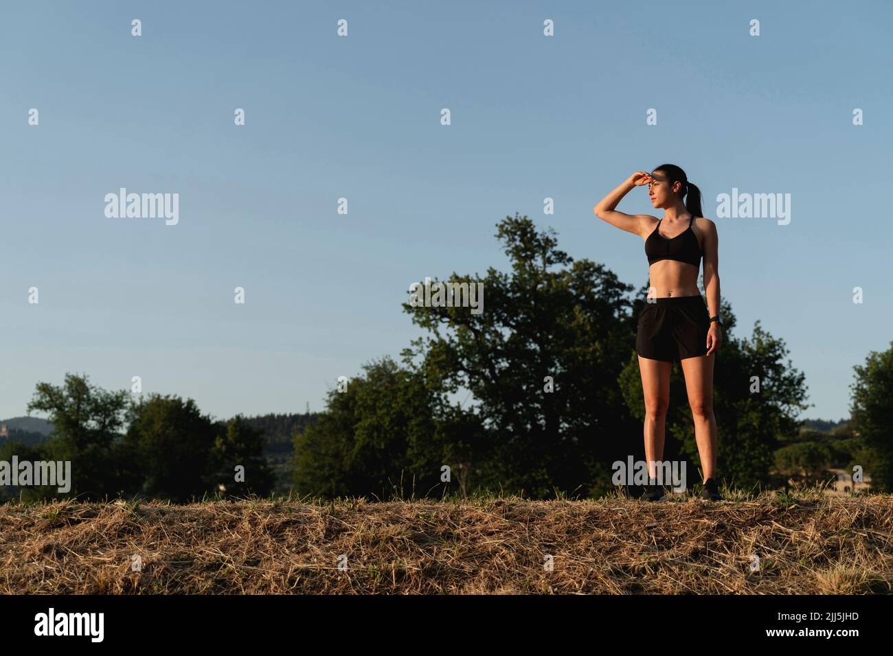 Woman shielding eyes from light hi-res stock photography and images - Alamy