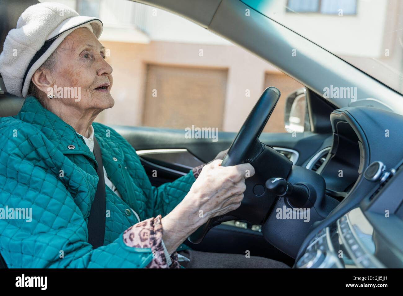 Senior woman driving car on road Stock Photo - Alamy