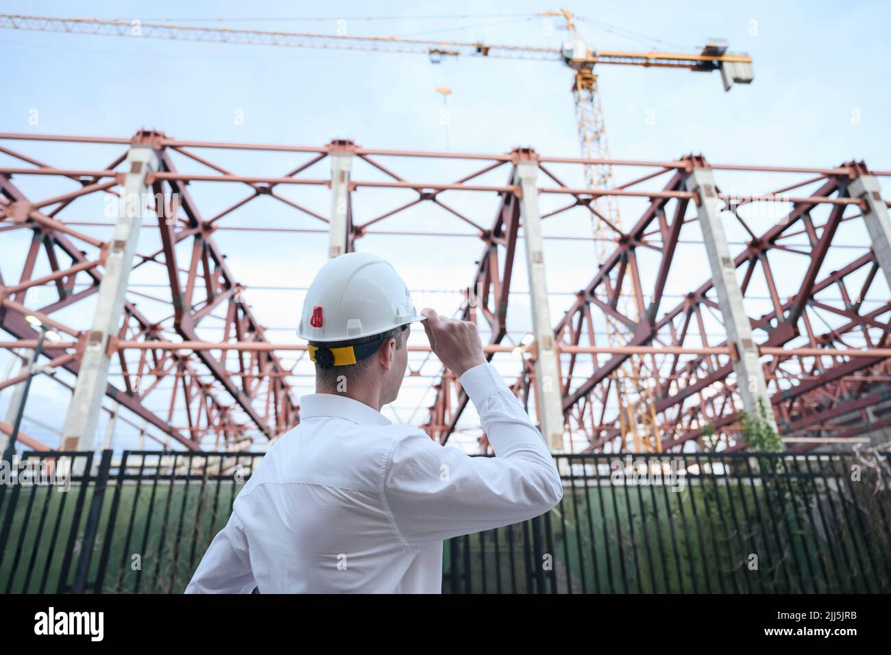 Engineer wearing hardhat standing in front of construction frame Stock ...