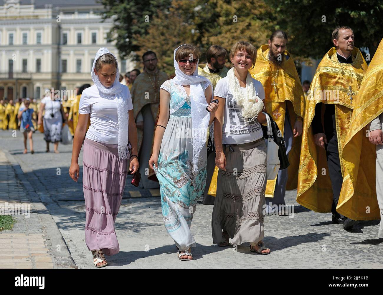 Three young woman orthodox christian followers walking down the street ...