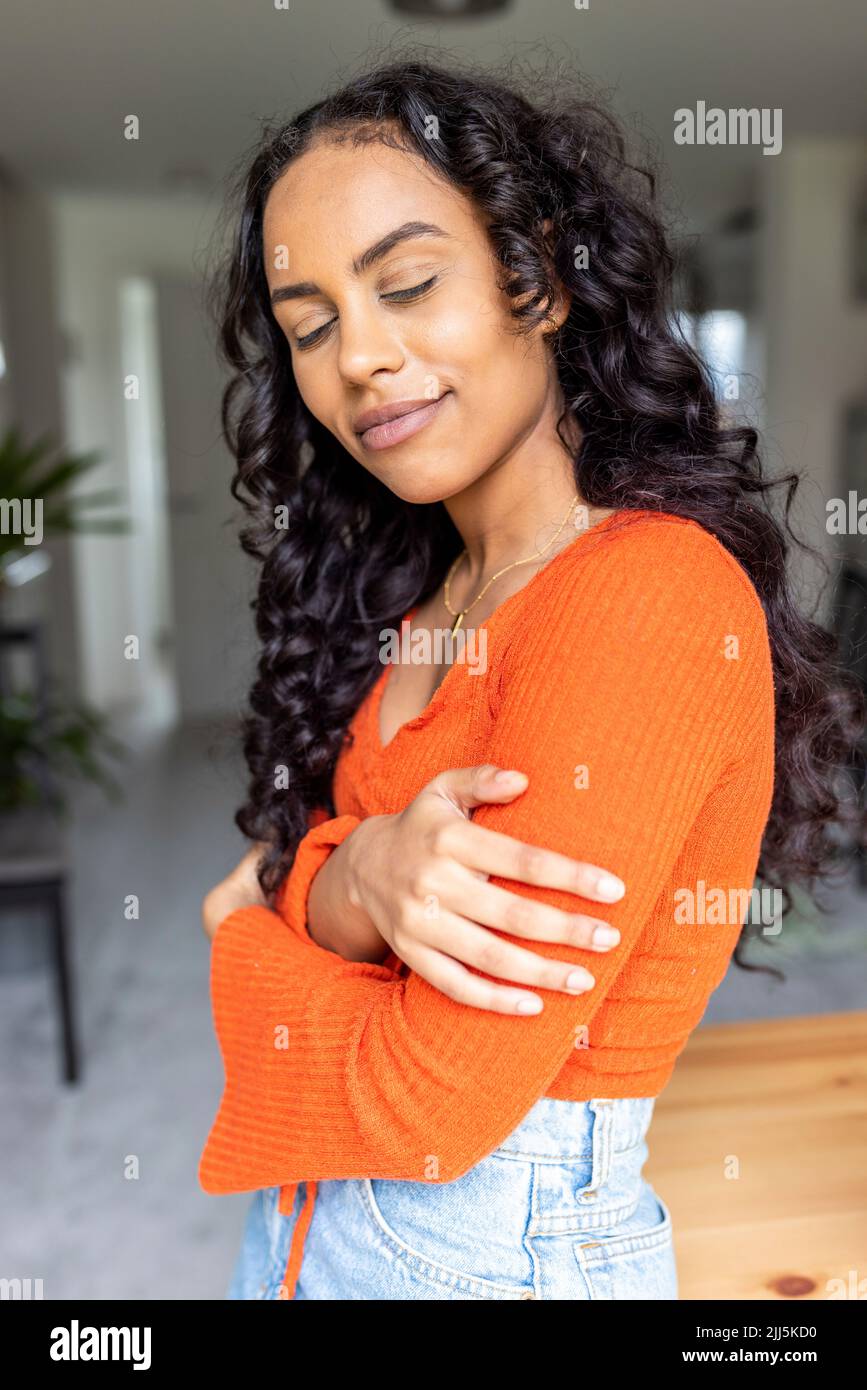 Woman hugging herself indoor hi-res stock photography and images - Alamy