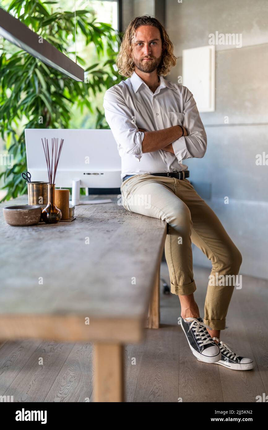 Shot attractive businessman sitting table hi-res stock photography and ...