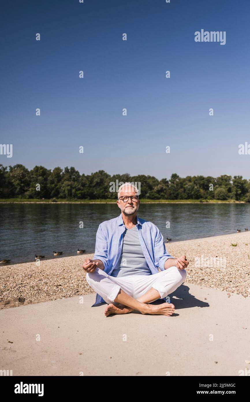 Smiling relaxed man meditating hi-res stock photography and images - Alamy