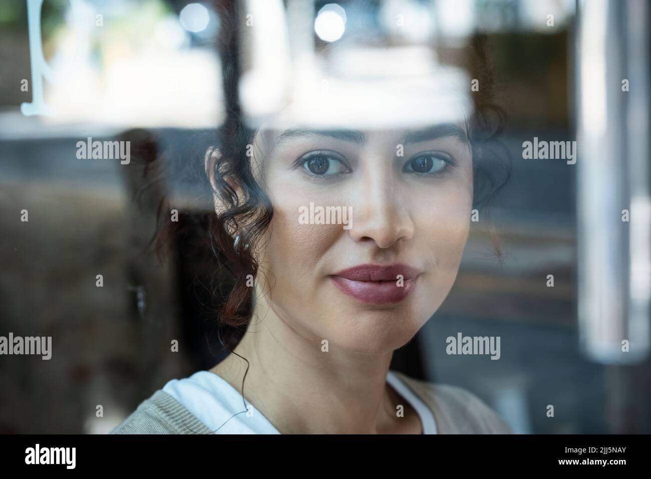 Beautiful woman seen through glass window Stock Photo - Alamy