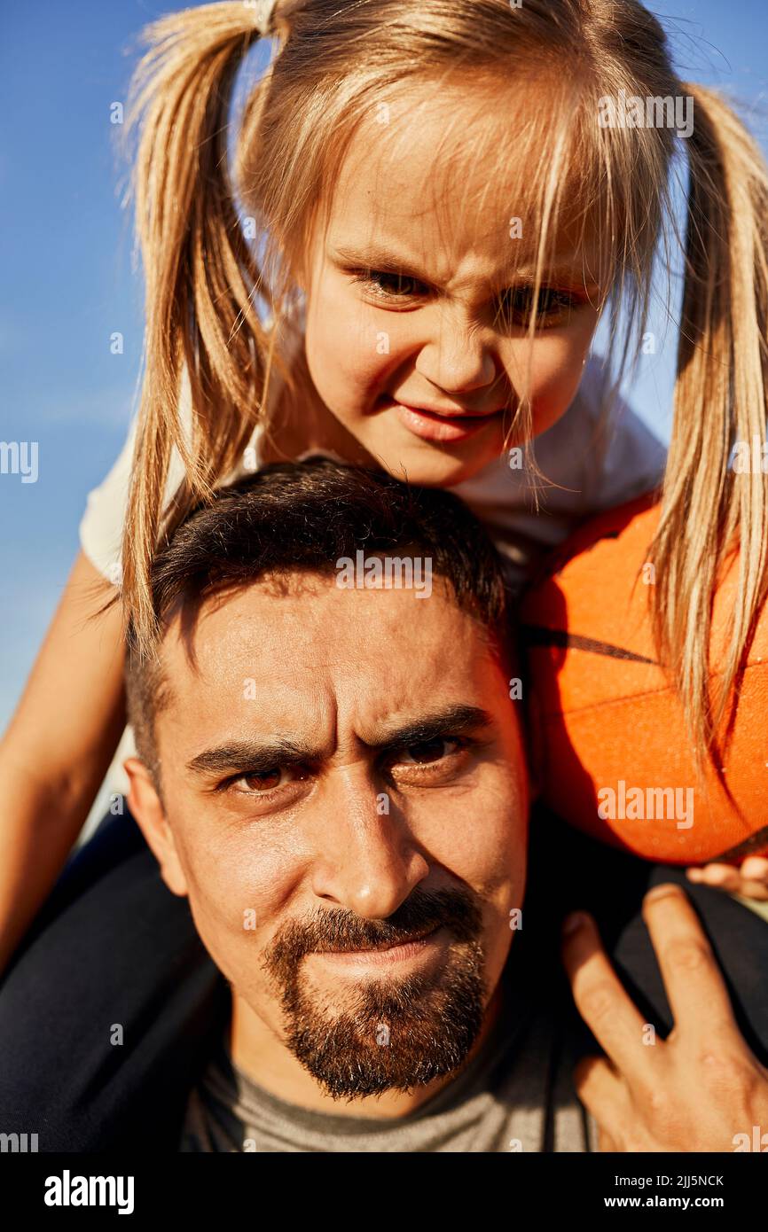 Man making face with daughter sitting on shoulders Stock Photo - Alamy