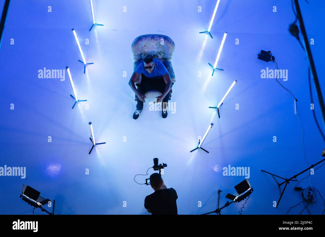 Cameraman filming rapper in studio set Stock Photo - Alamy