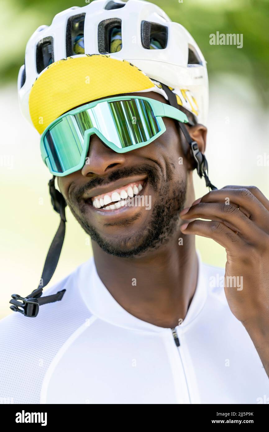 Happy cyclist in cycling helmet and sunglasses Stock Photo - Alamy