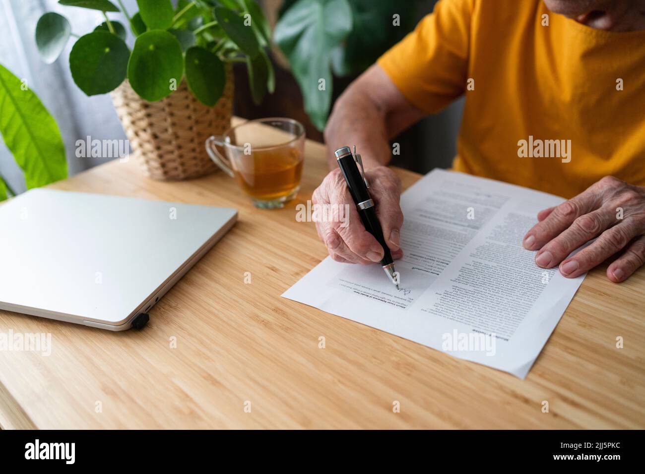Senior woman signing document hi-res stock photography and images - Alamy