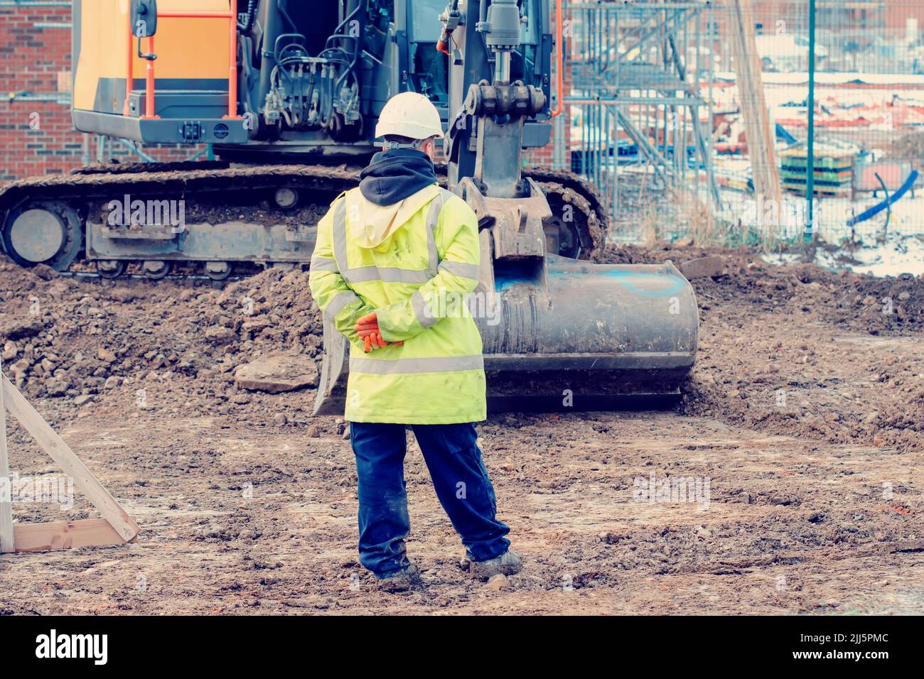 Excavator digging and levelling ground on construction site. Digging to ...