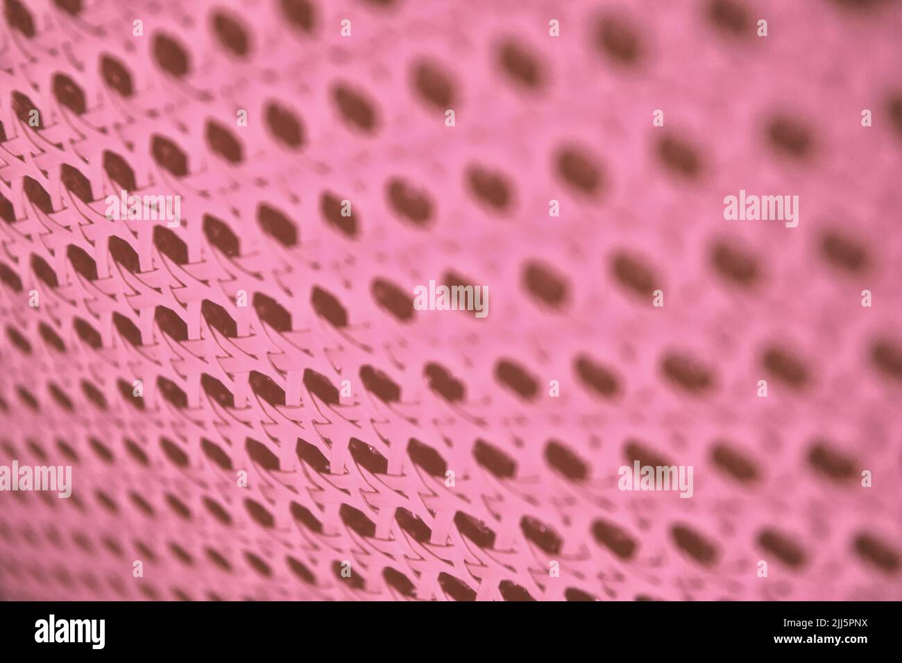Abstract pale pink perforated surface of weave threads. Digital ...