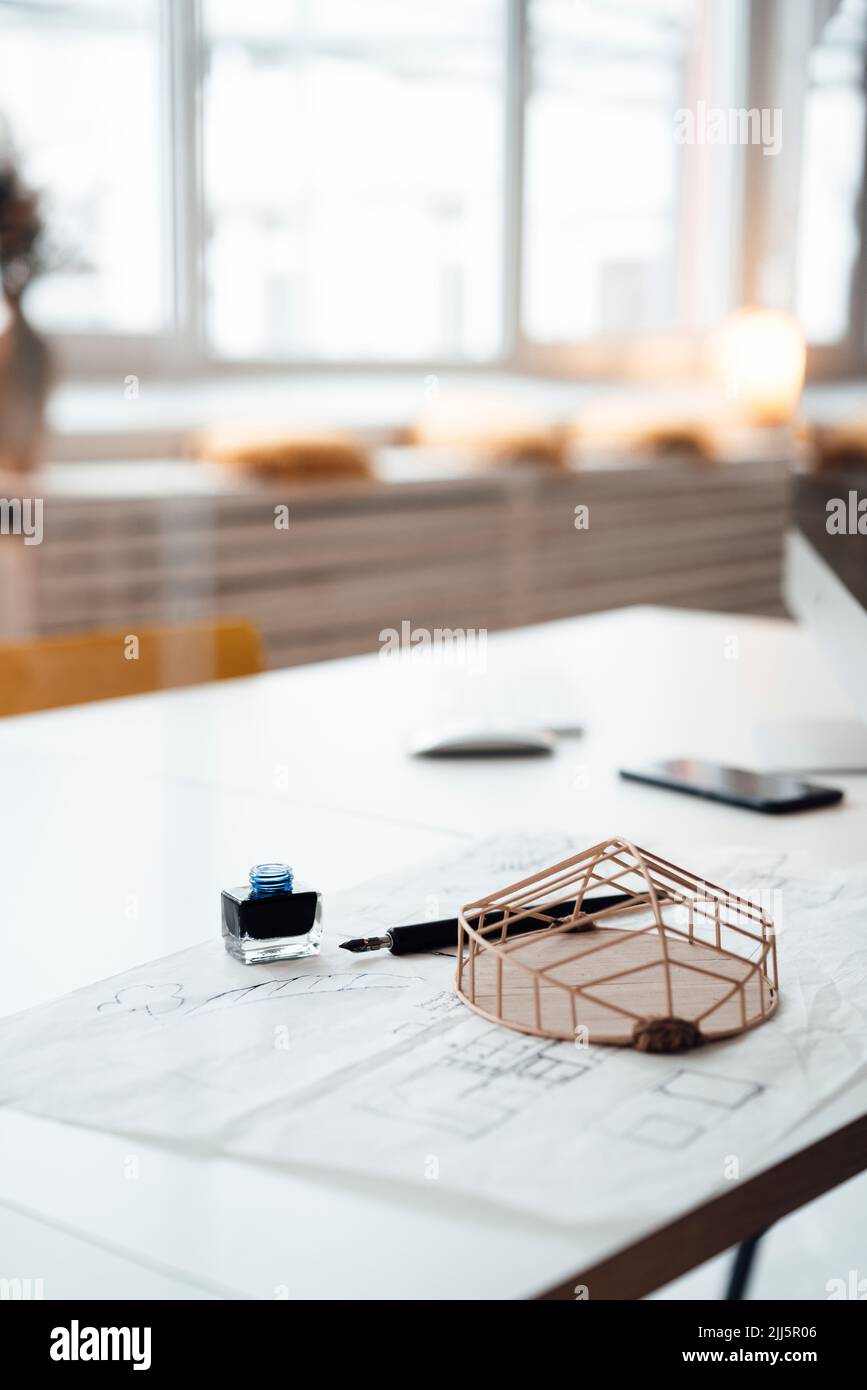 Architectural model with blueprint on desk Stock Photo - Alamy