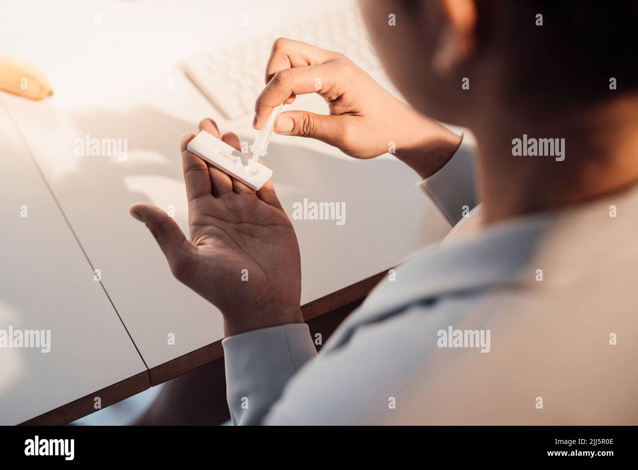 Businesswoman taking pregnancy test at desk Stock Photo - Alamy
