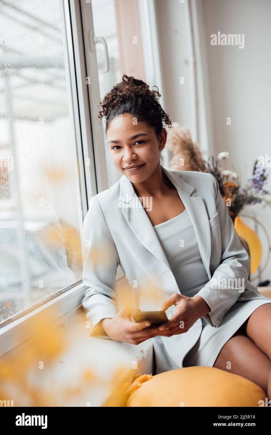 Woman leaning on windowsill hi-res stock photography and images - Alamy