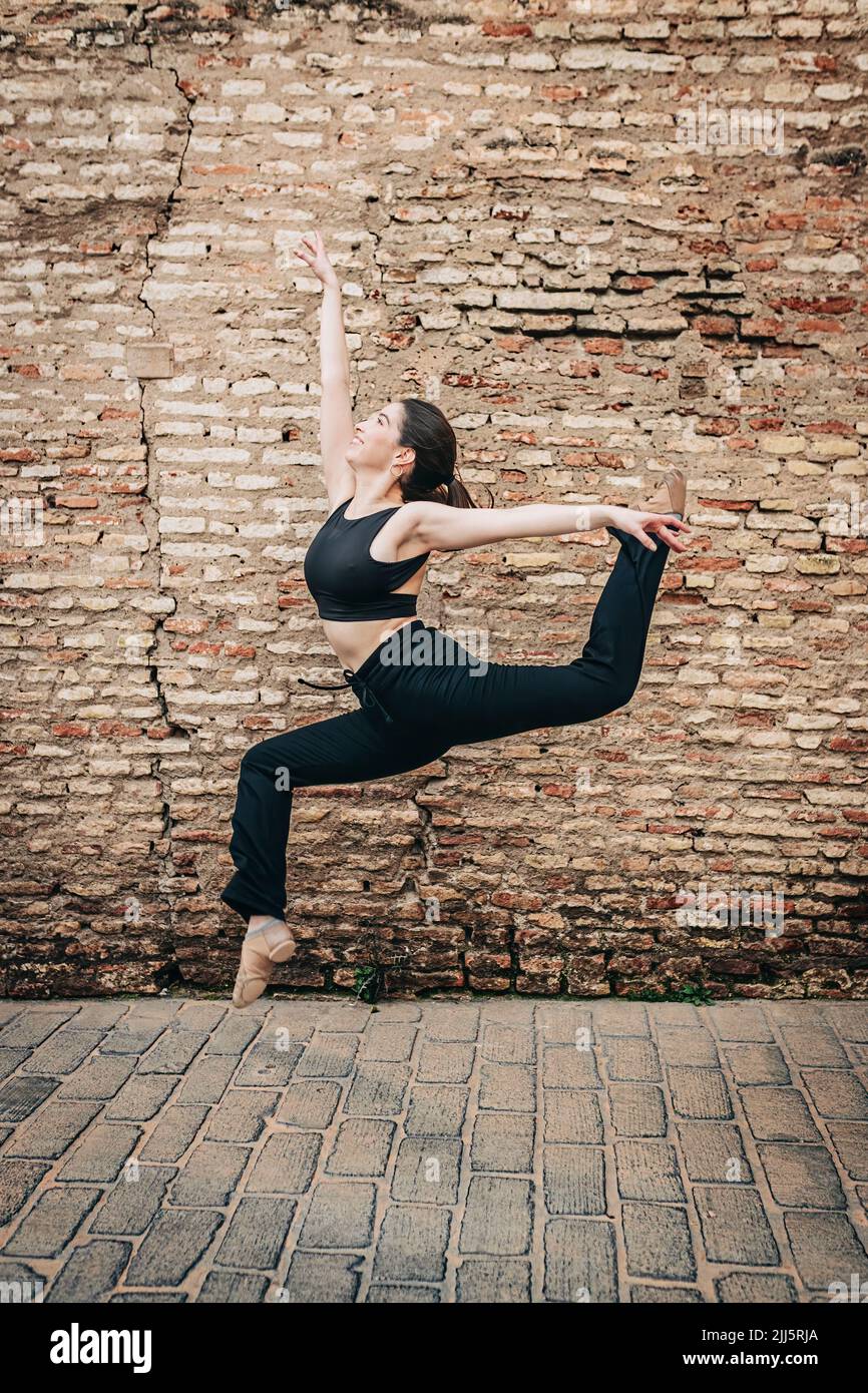 Ballet dancer dancing in front of brick wall Stock Photo - Alamy