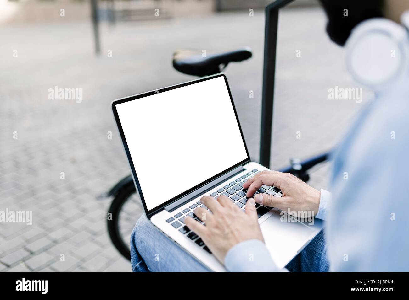 Businessman typing on laptop with blank screen Stock Photo - Alamy
