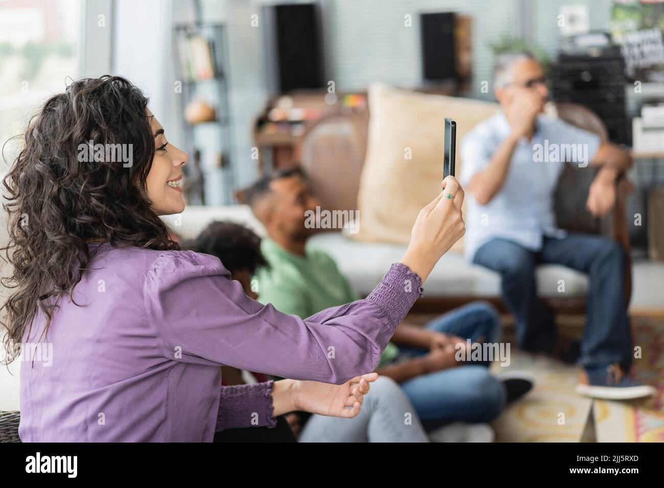 Happy businesswoman filming through smart phone Stock Photo - Alamy