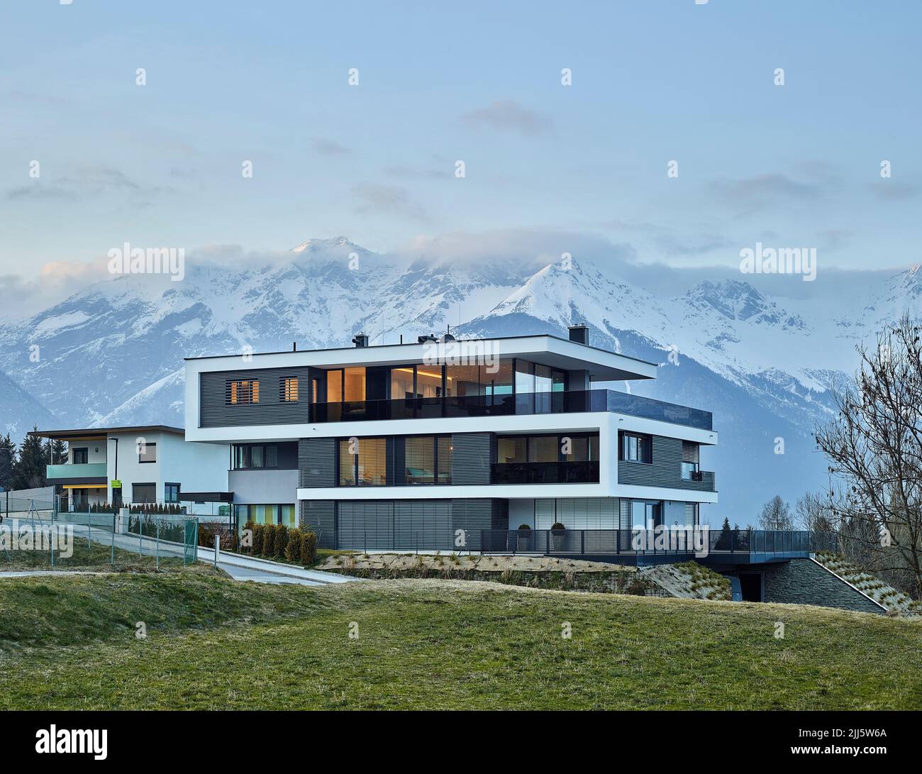 Austria, Tyrol, Facade of luxurious three-storey house in mountains ...