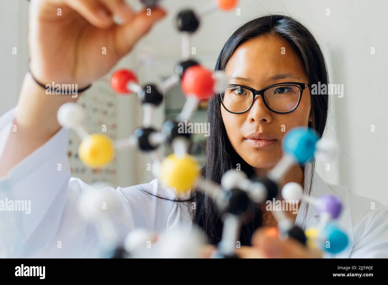 Scientist examining DNA model in laboratory Stock Photo - Alamy
