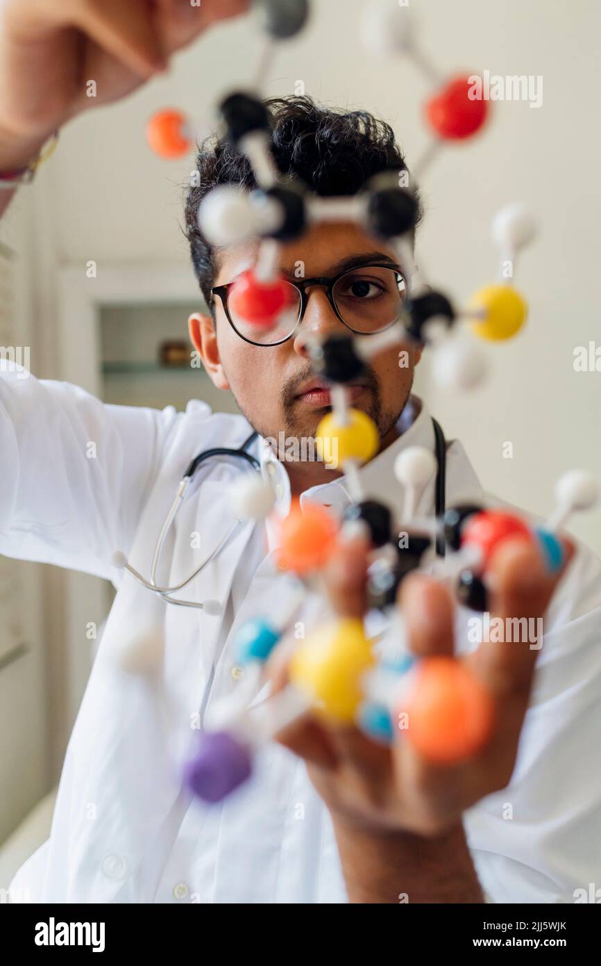 Young scientist examining helix model in laboratory Stock Photo - Alamy