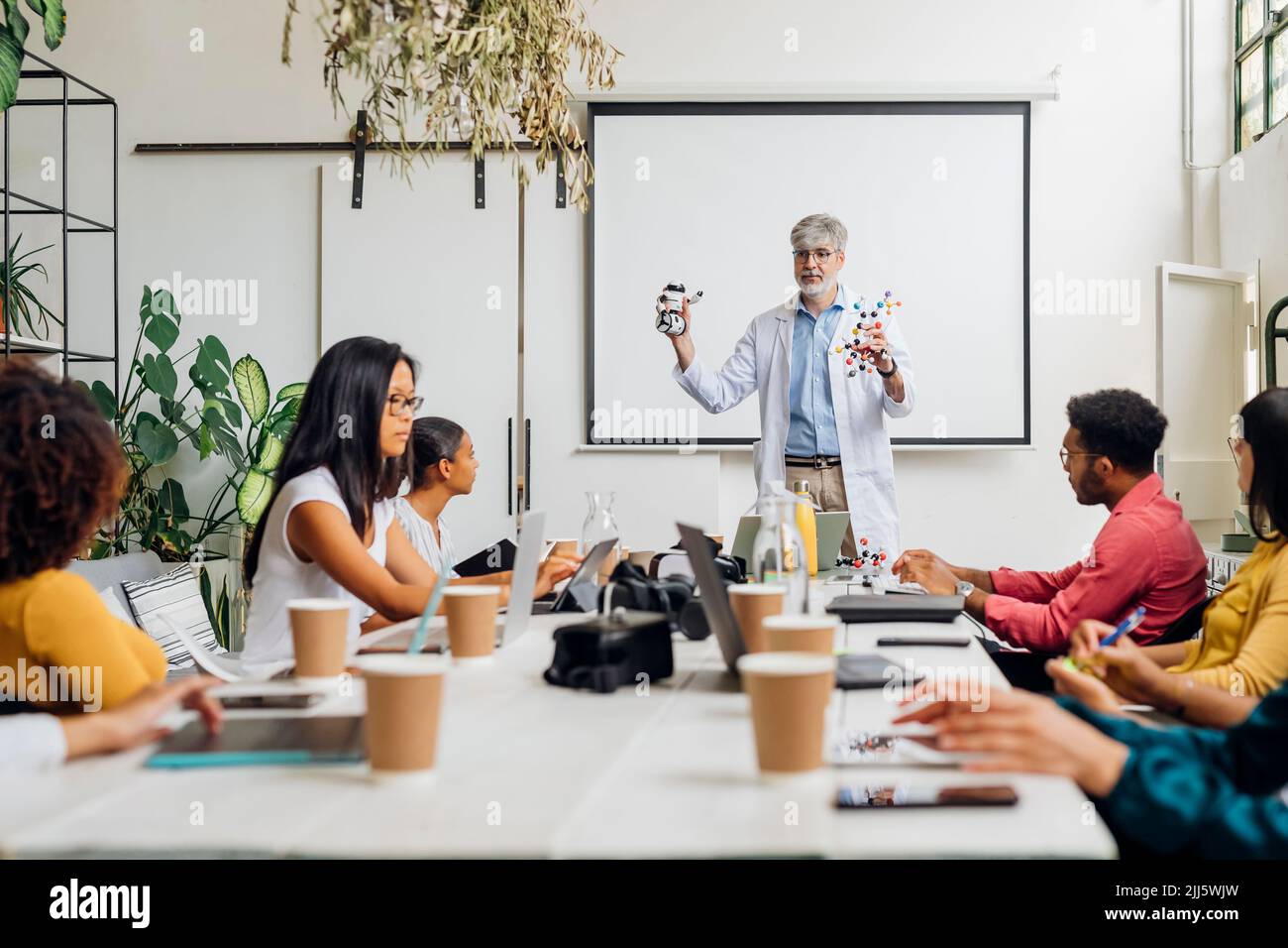 Scientist explaining molecular model business hi-res stock photography ...
