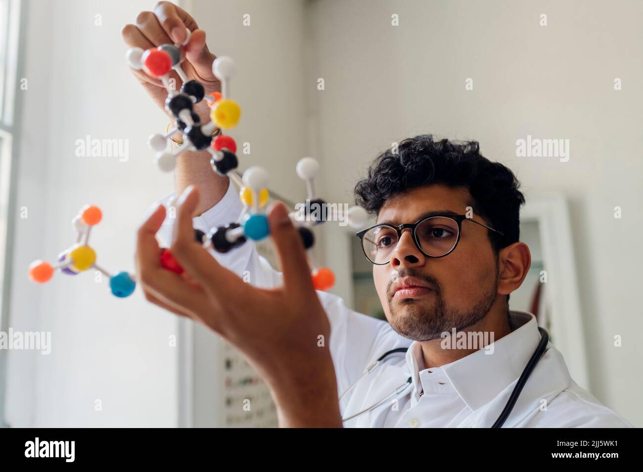 Young scientist analyzing helix model in laboratory Stock Photo - Alamy