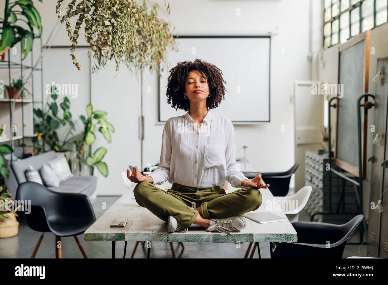 Woman meditating office seat hi-res stock photography and images - Alamy