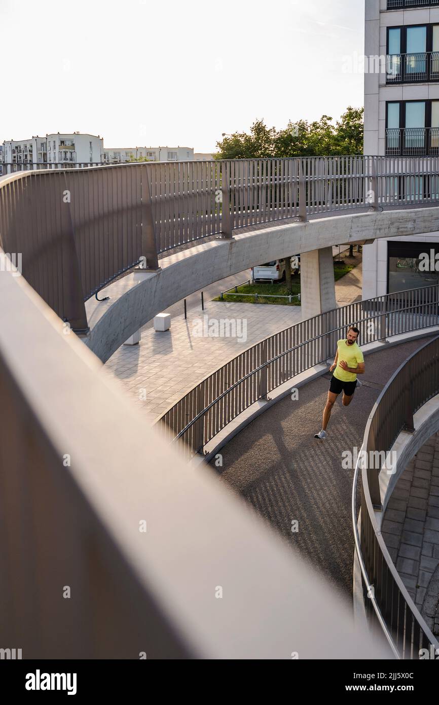 Man running on elevated walkway Stock Photo - Alamy