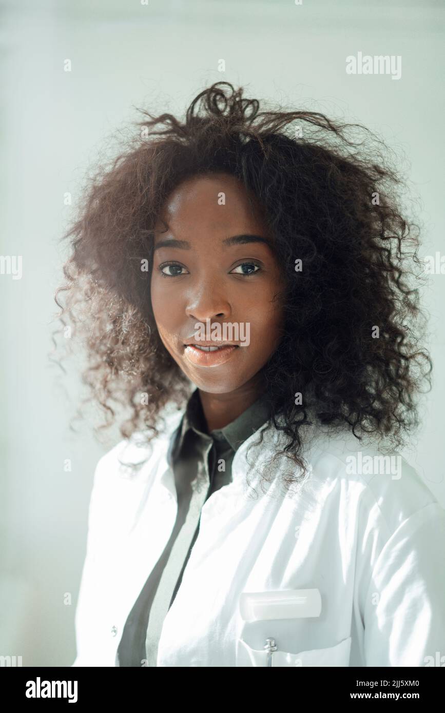 Female doctor with curly hair against white background Stock Photo - Alamy