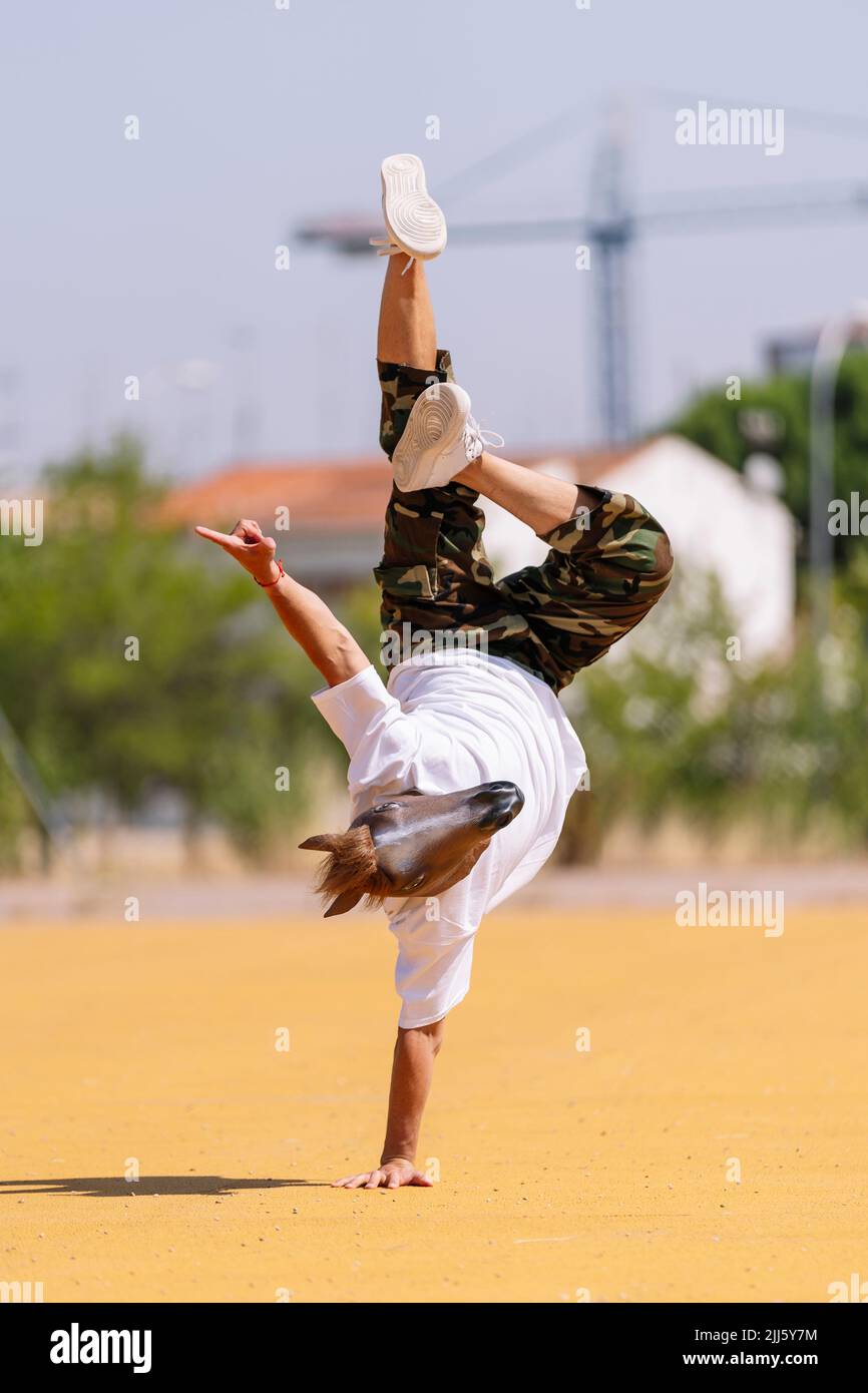 Dancer wearing animal mask doing handstand Stock Photo - Alamy