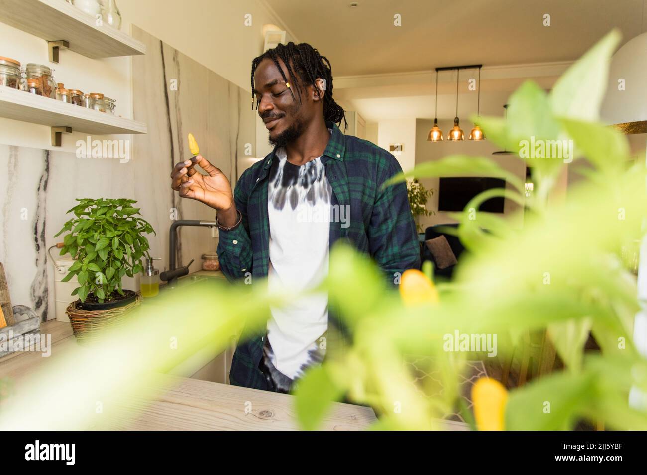Smiling man holding chili pepper hi-res stock photography and images ...