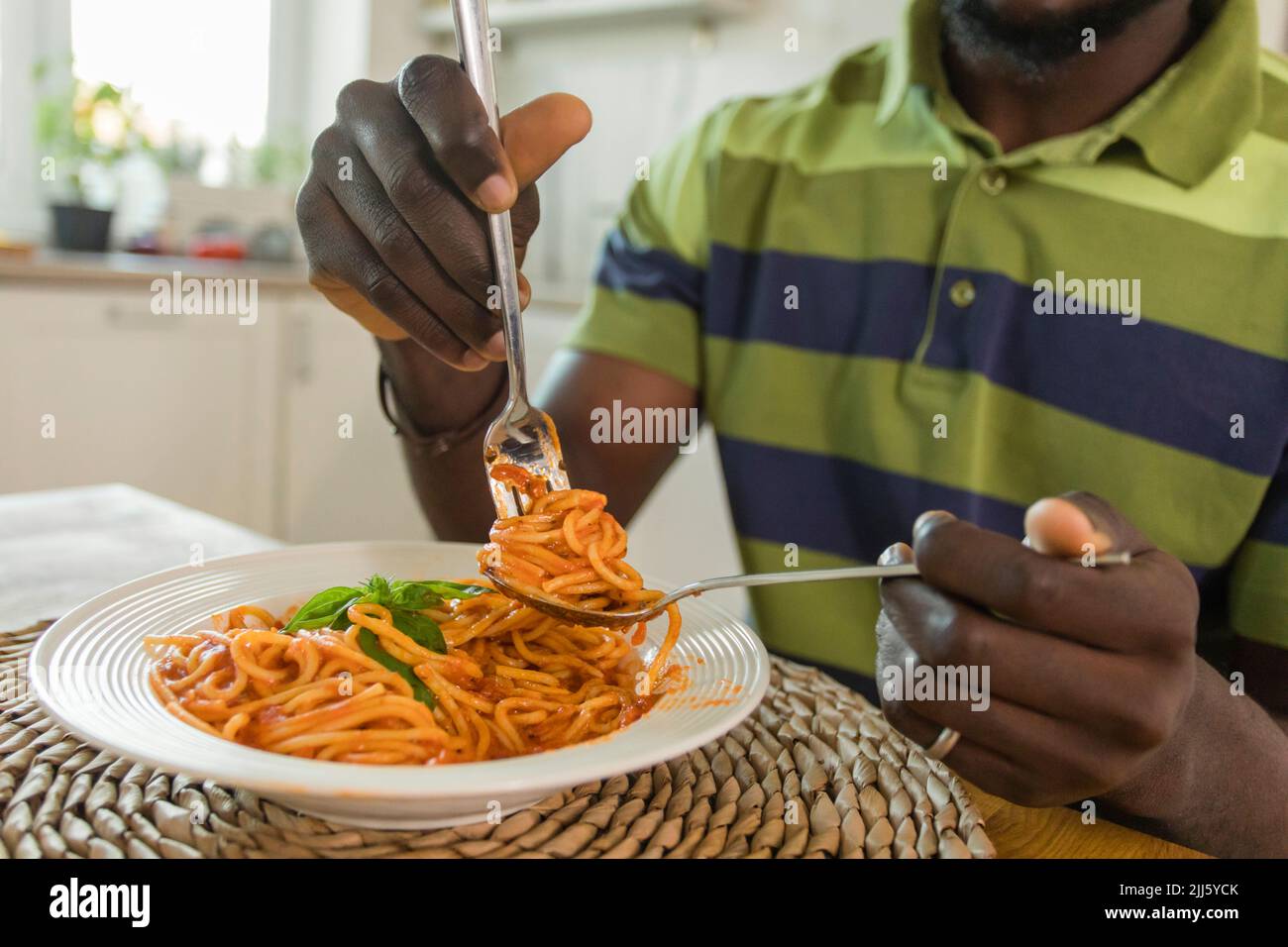 Hands of man holding fork with spaghetti at home Stock Photo - Alamy