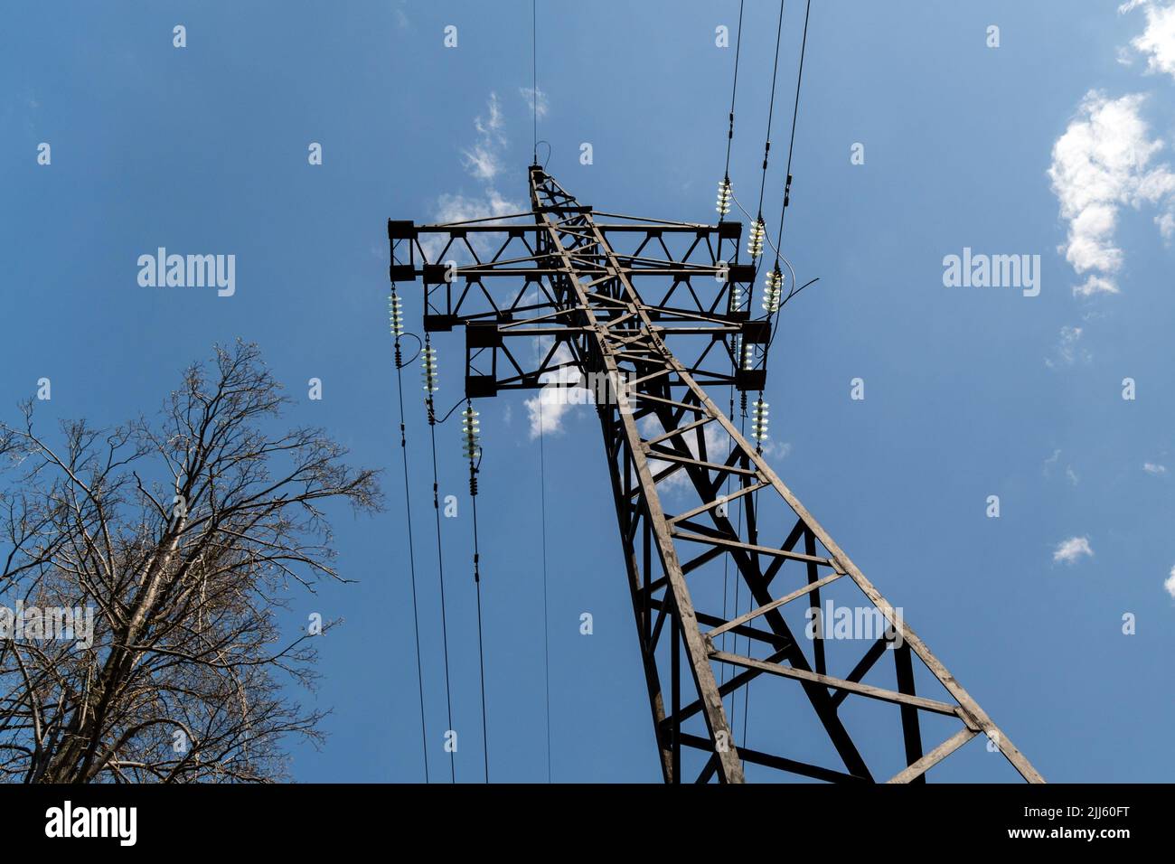 High voltage grid tower with wire cable at distribution station. energy ...