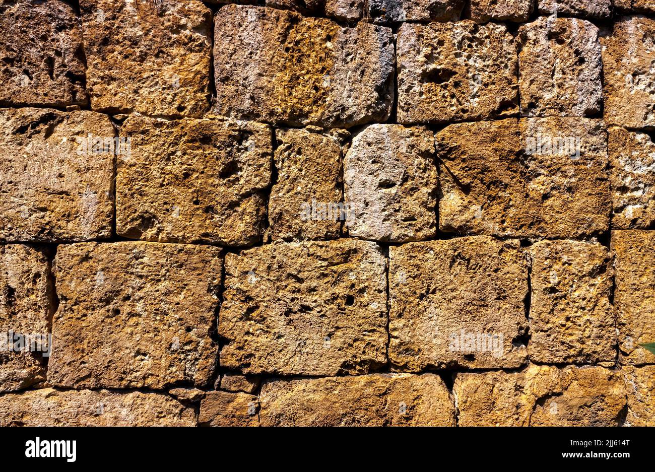 The texture of an ancient stone wall made of tuff Stock Photo - Alamy