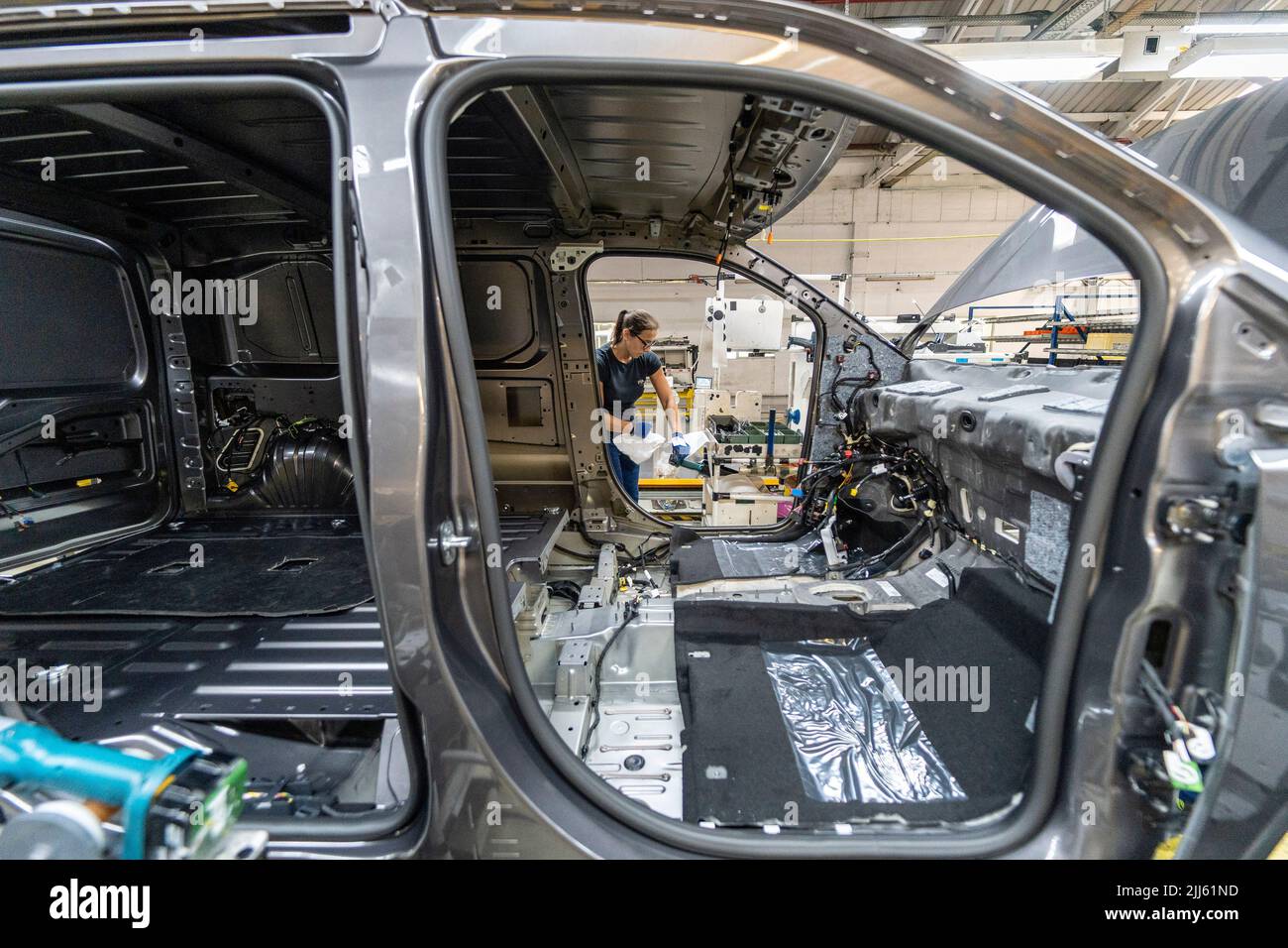 Female worker at car factory assembly line Stock Photo - Alamy